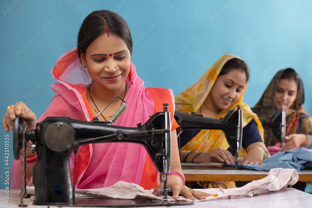 A group of rural women working on sewing machines. Stock Photo | Adobe ...