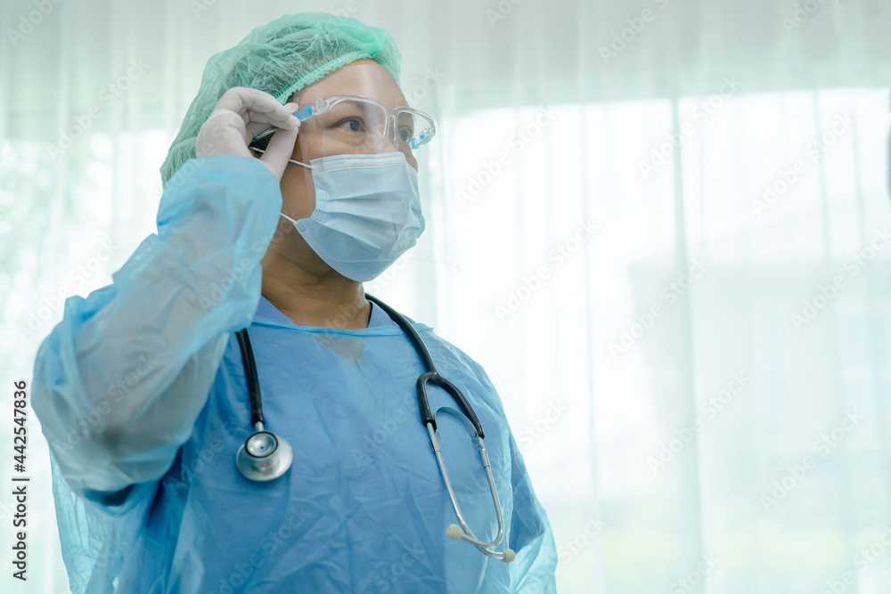 Asian doctor wearing face shield and PPE suit new normal to check ...
