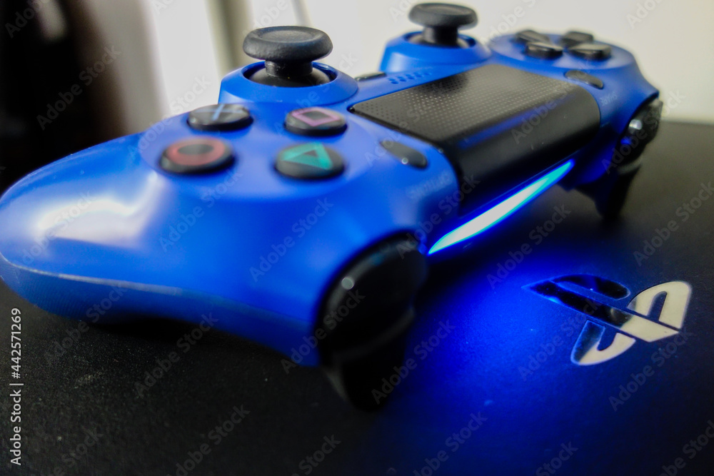 Sony Playstation logo illuminated on blue light from game controller ...