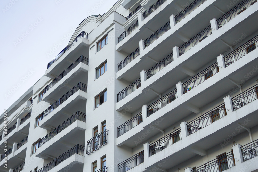 View from below at an angle of the facade of a new, multi-storey, high ...