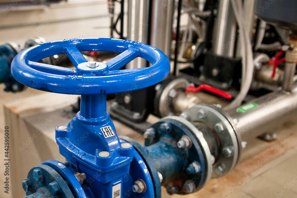 Closing valve on water pump station is pipeline with water tanks Stock ...