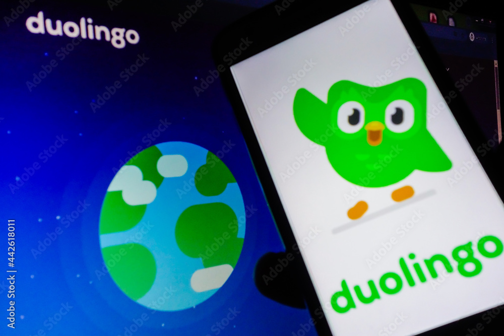 smartphone with Duolingo language app logo on screen. Blurred ...
