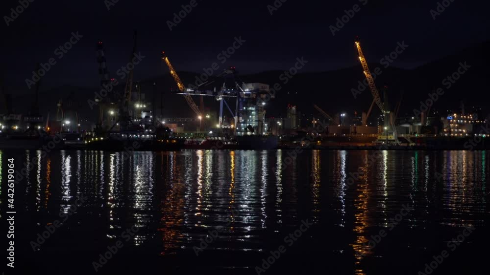 Cargo port. Night time. Port lights. Cargo cranes. Dry cargo ships ...