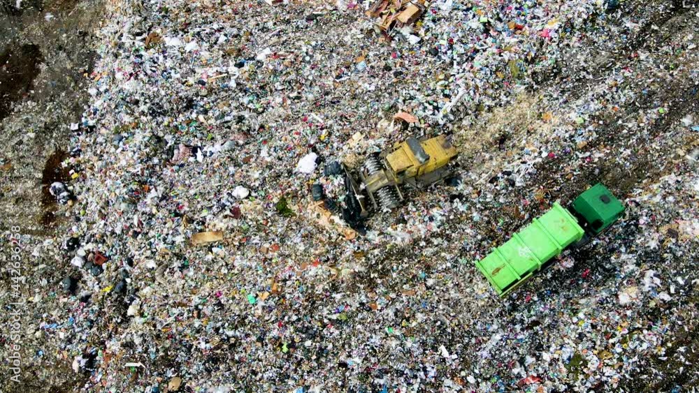 Landfill bulldozer during working rubbish at garbage. Waste ...