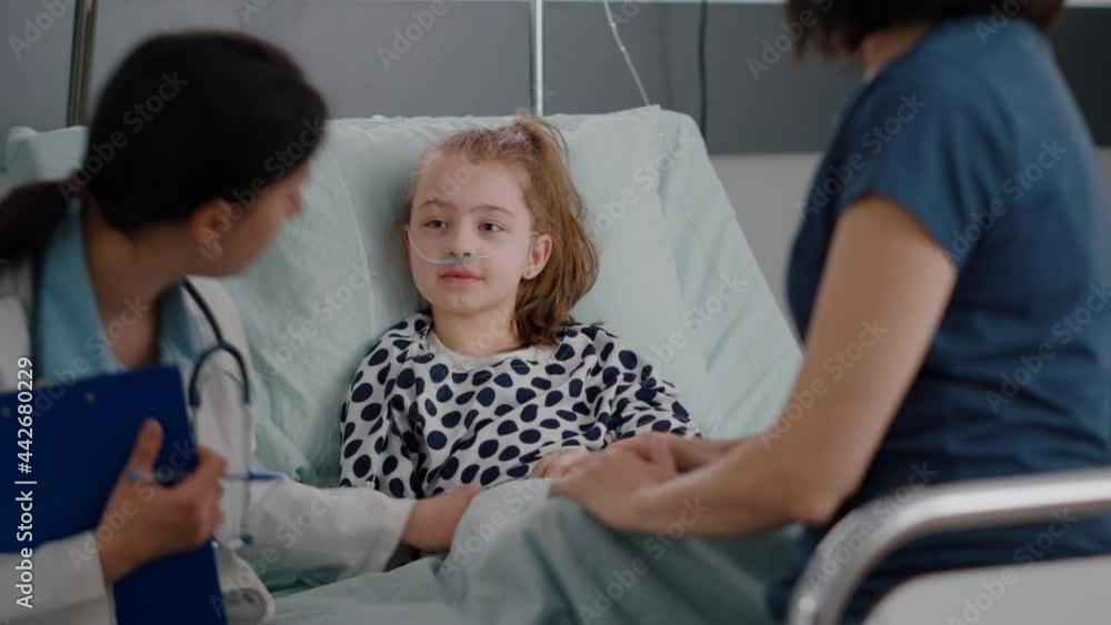 Mother sitting with sick little daughter recovering after medical ...