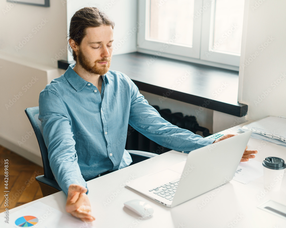 Relief stress at work. Calm male office worker with closed eyes doing ...