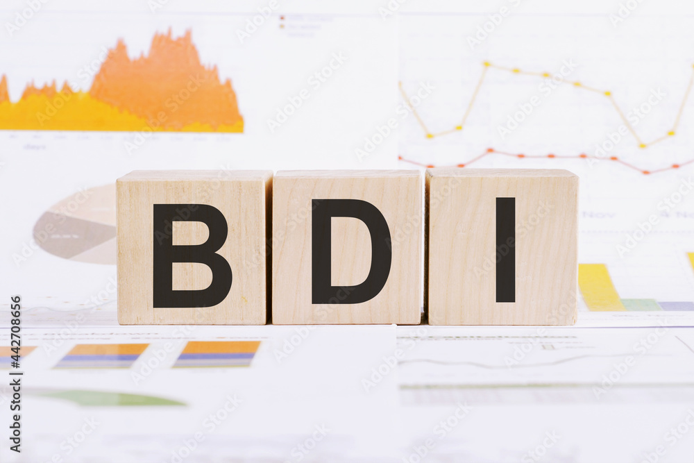 On a light background, graphs, diagrams and wooden cubes with the word ...