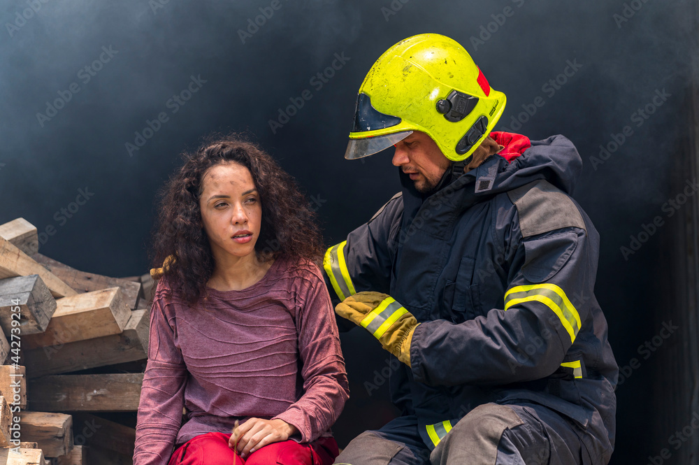 Foto de Firefighter emergency rescue help young woman from dangerous ...