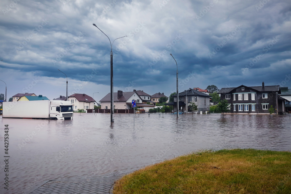 Extreme heavy rain storm weather. Flooded streets of the neighborhood ...