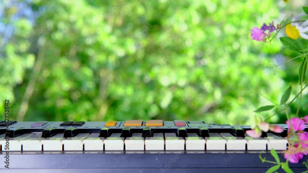female hand plays scales on the keyboard of the electronic piano in the ...
