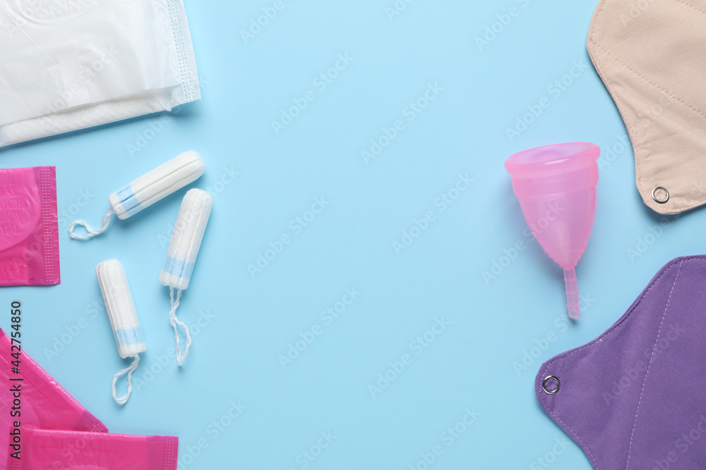 Different menstrual hygiene products on light blue background, flat lay ...