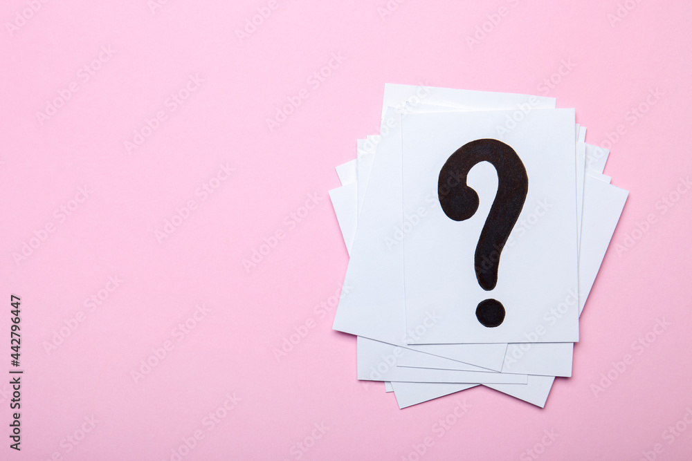 Paper cards with question marks on pink background. Pile of question ...