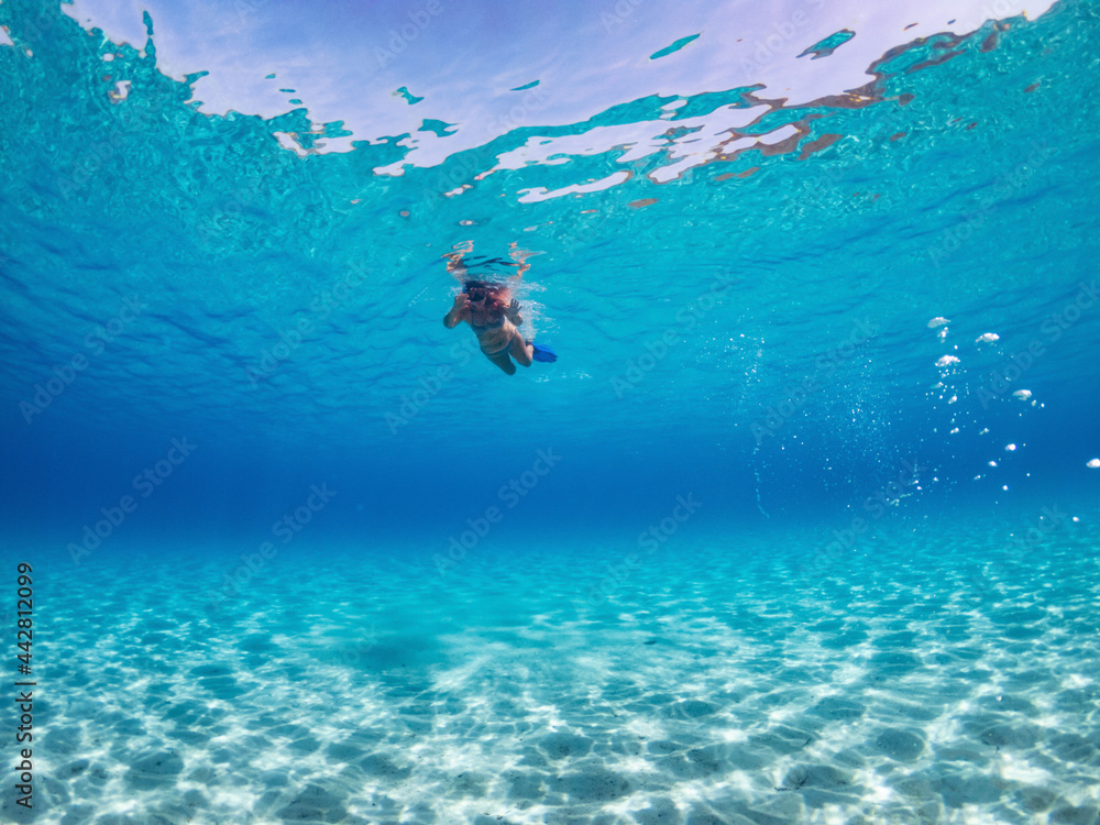 Woman who greets the photographer underwater. Lady all alone in the ...
