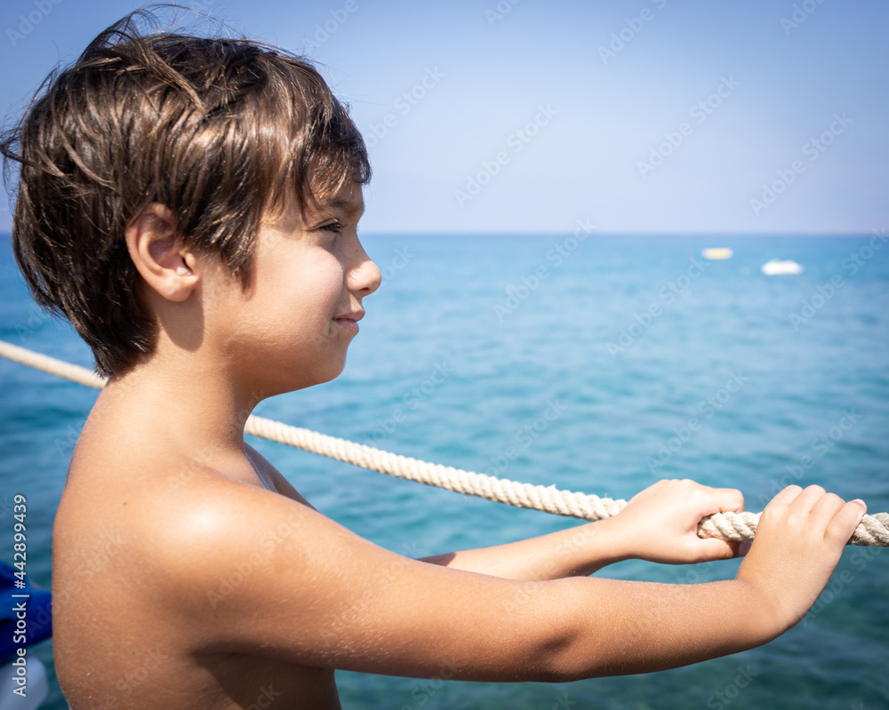 Little cute boy on sea pier enjoying vacation Stock Photo | Adobe Stock