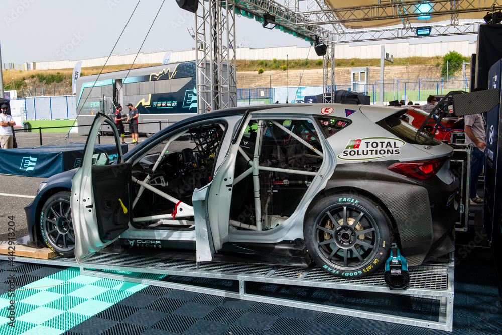 Racing touring electric car Cupra at charging station in circuit Stock ...