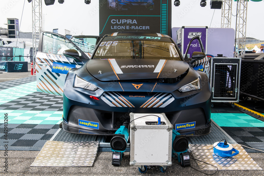 Racing touring electric car Cupra at charging station in circuit Stock ...