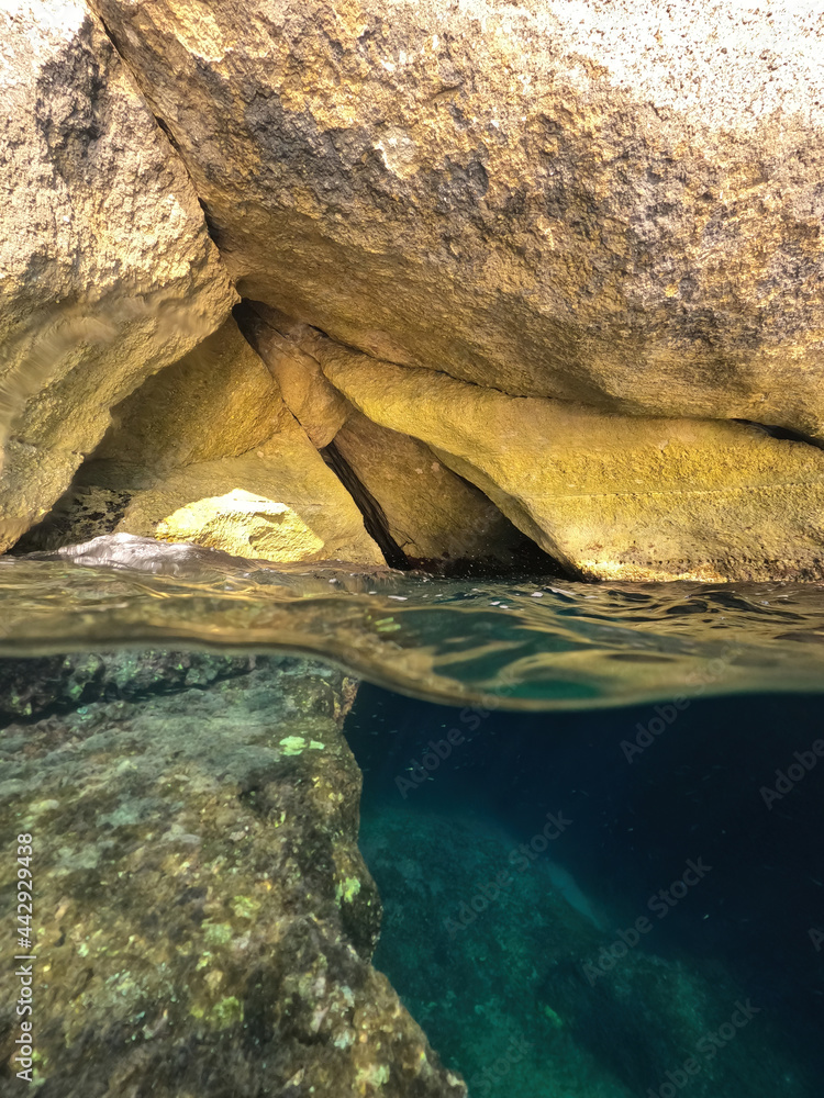 Underwater sea level split photo of iconic caves of Sarakiniko a ...