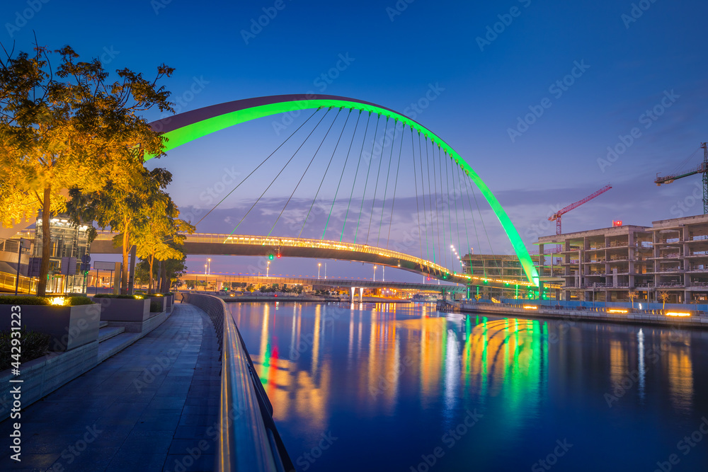 Illuminated in green color Tolerance Bridge in Dubai with an unusual ...