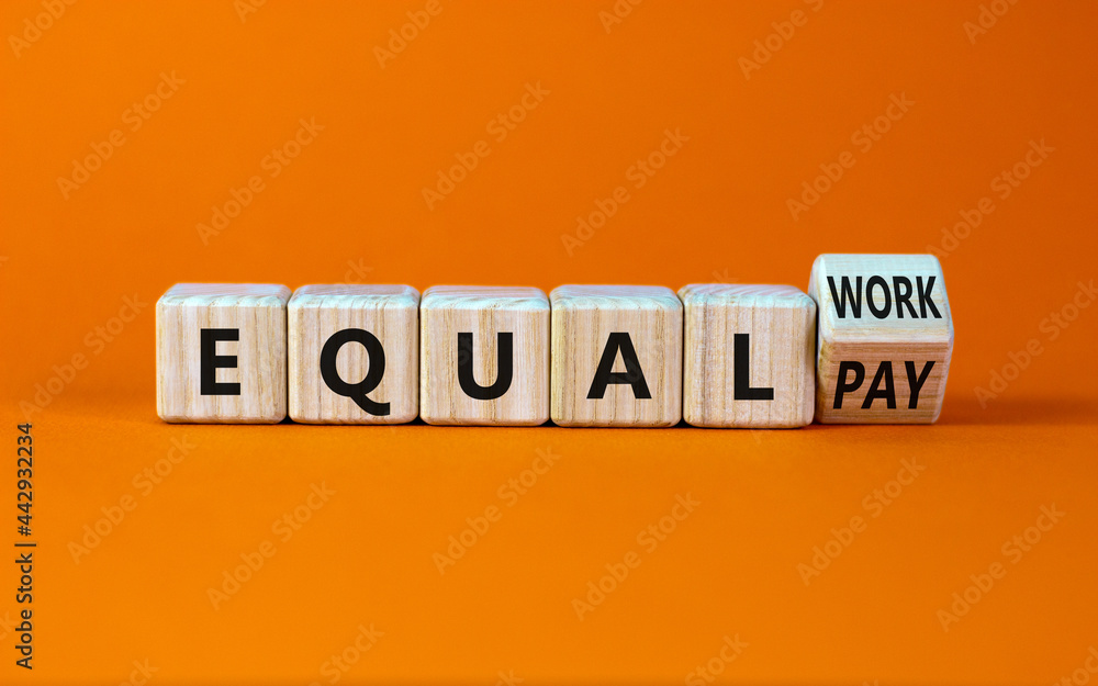 Equal pay and work symbol. Turned the wooden cube and changed words ...