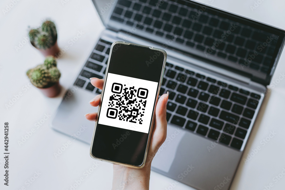 QR code scanning payment and cashless technology concept. Female hand ...