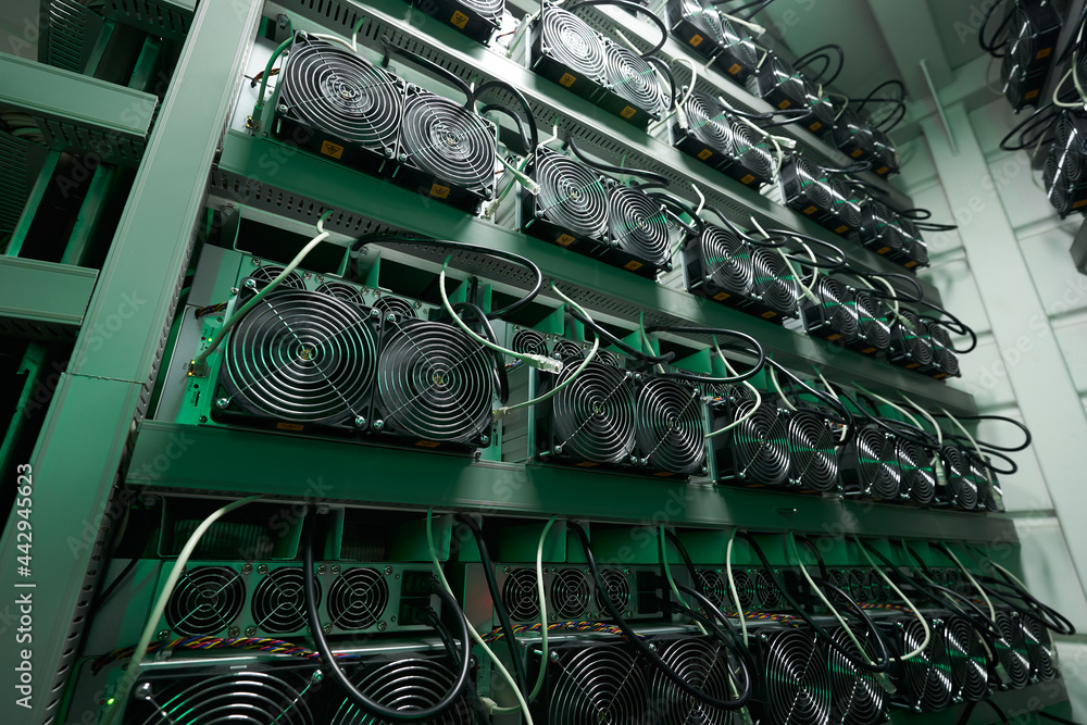 Bitcoin miners in large farm. ASIC mining equipment on stand racks mine ...
