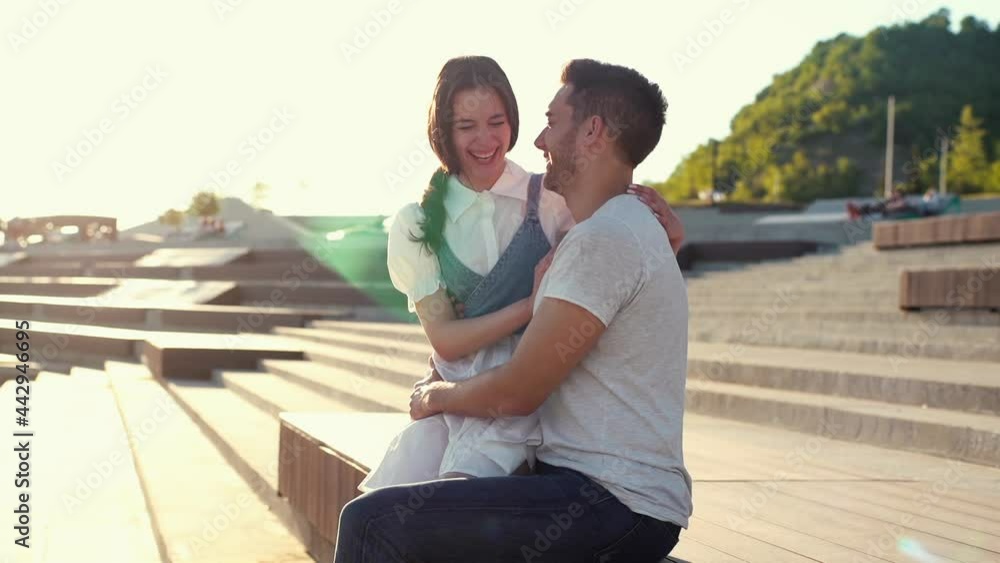 Tracking shot of cheerful boyfriend and girlfriend enjoying time ...