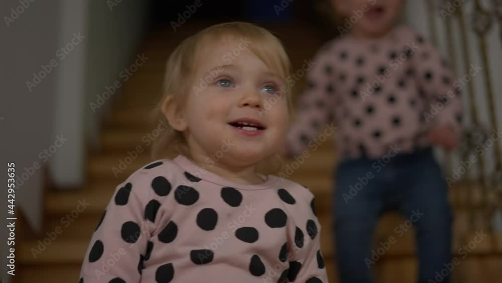 Joyful cute baby girl dancing in slow motion with blurred ...