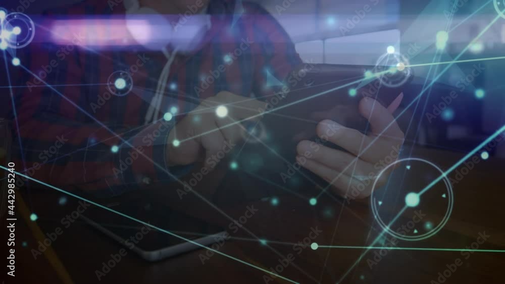 Animation of networks of connections with icons over man using tablet ...