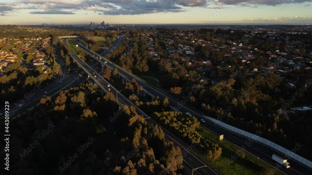 Backward Aerial of Cars on City Highway Expressway with Trees and ...