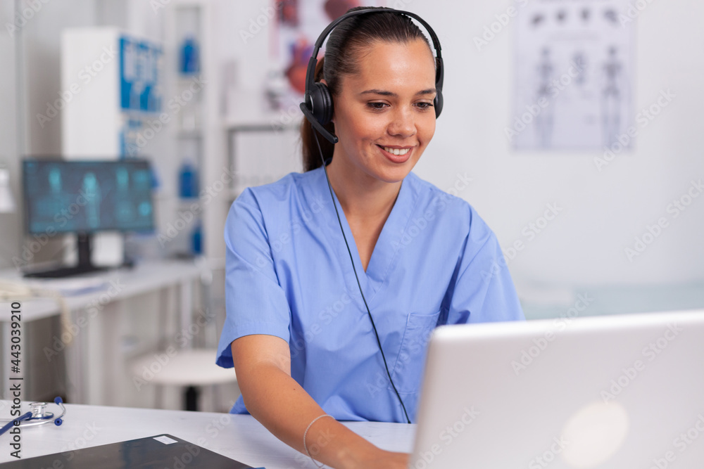 Medical staff talking with patient about prescription wearing headset ...