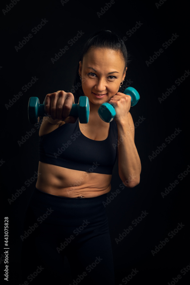 Portrait in front of a black background, of an Asian fighting athlete ...