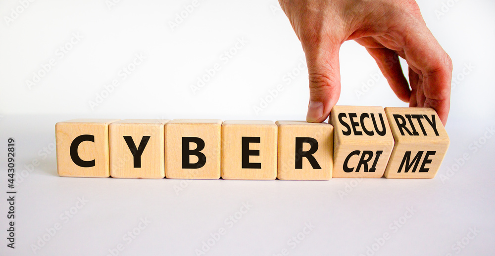 Cyber-security vs cybercrime symbol. Businessman turns wooden cubes ...