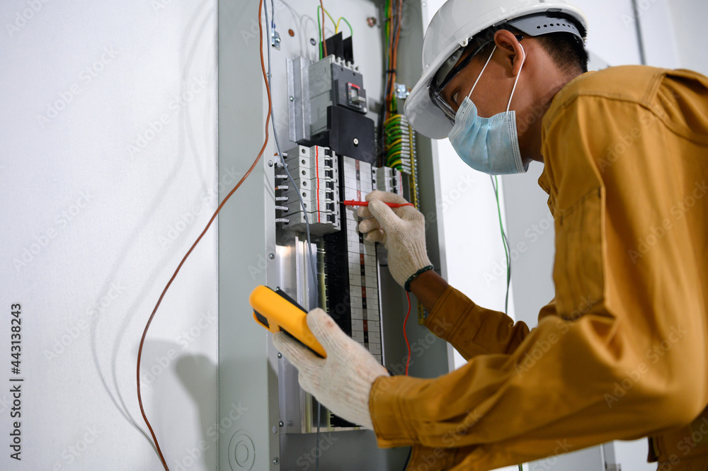 Electrician engineer using digital multimeter test current electric in ...
