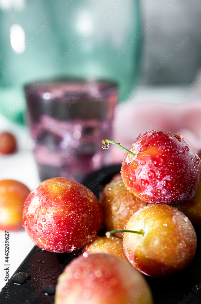 Small, red, ripe plums from the garden just picked from the tree ...