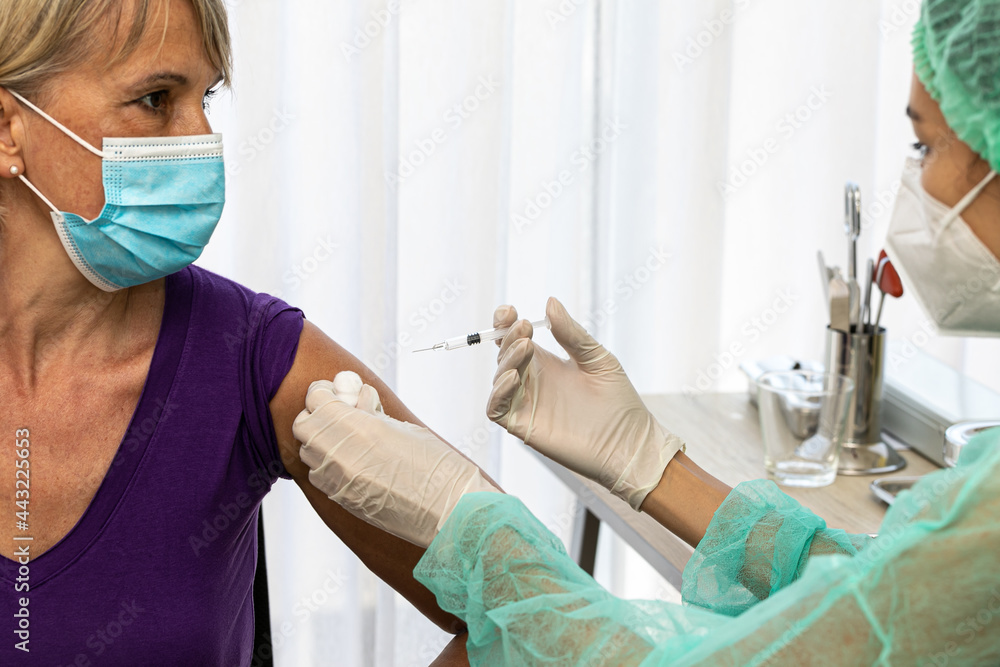 Medical Nurse in Safety Gloves and Protective Mask is Making a Vaccine ...