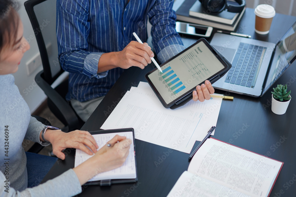 Office work concept a businessman showing a bar graph presenting ...