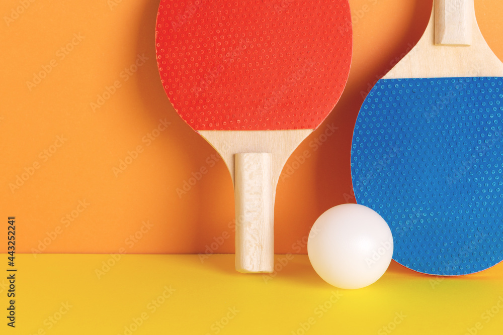 Sport background with red and blue ping-pong rackets and white ball ...