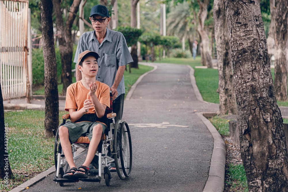Foto Stock Happy asian disabled teen boy on wheelchair smiling face as ...