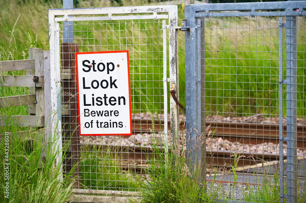 Stop look listen safety road sign at railway train station danger ...