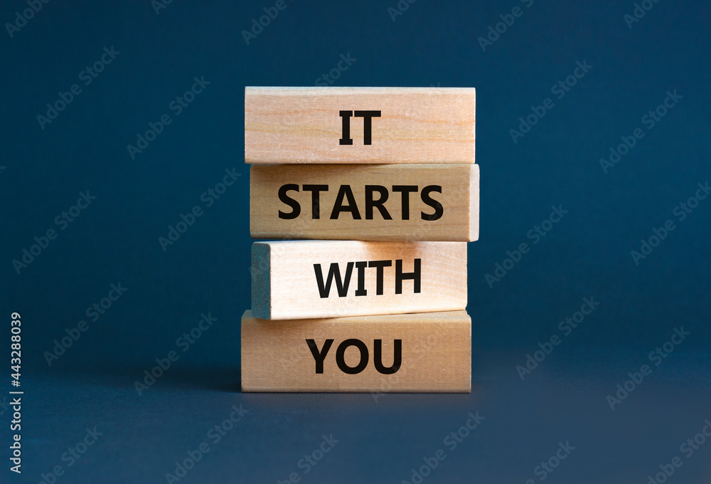 It starts with you symbol. Wooden blocks with words 'it starts with you ...