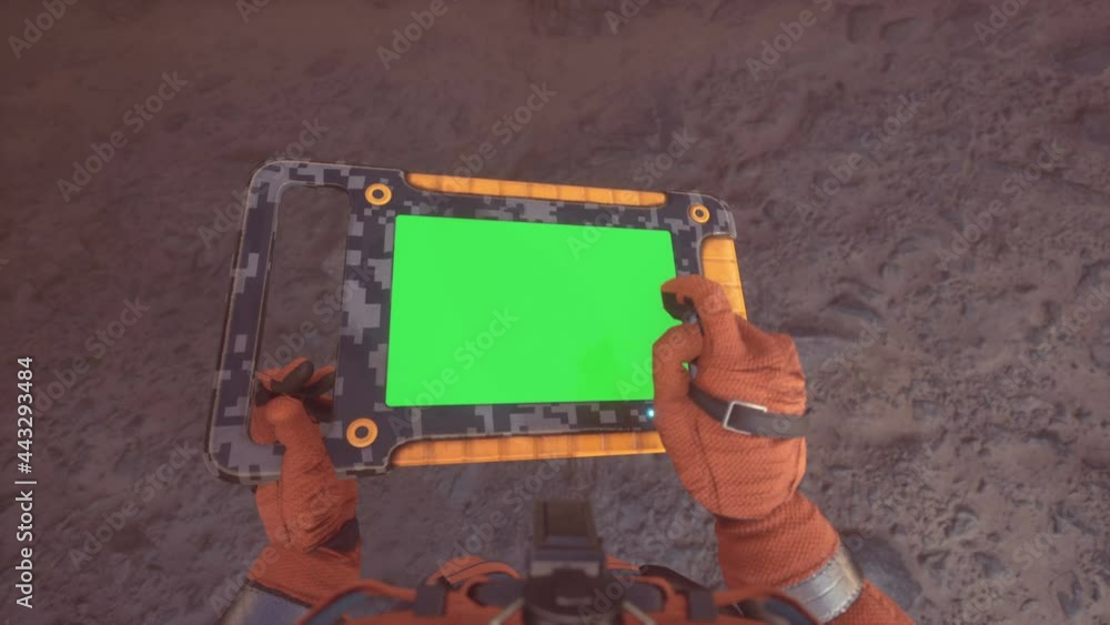 An astronaut on an alien, dusty planet is working on his tablet with a ...