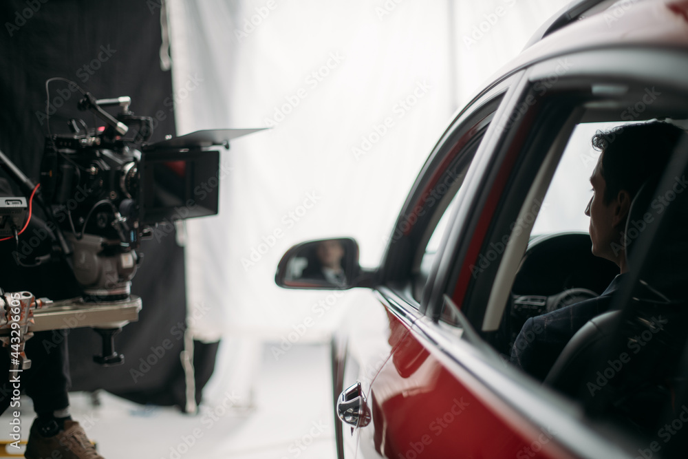 Professional male actor works in the frame on the set. Shooting with a ...