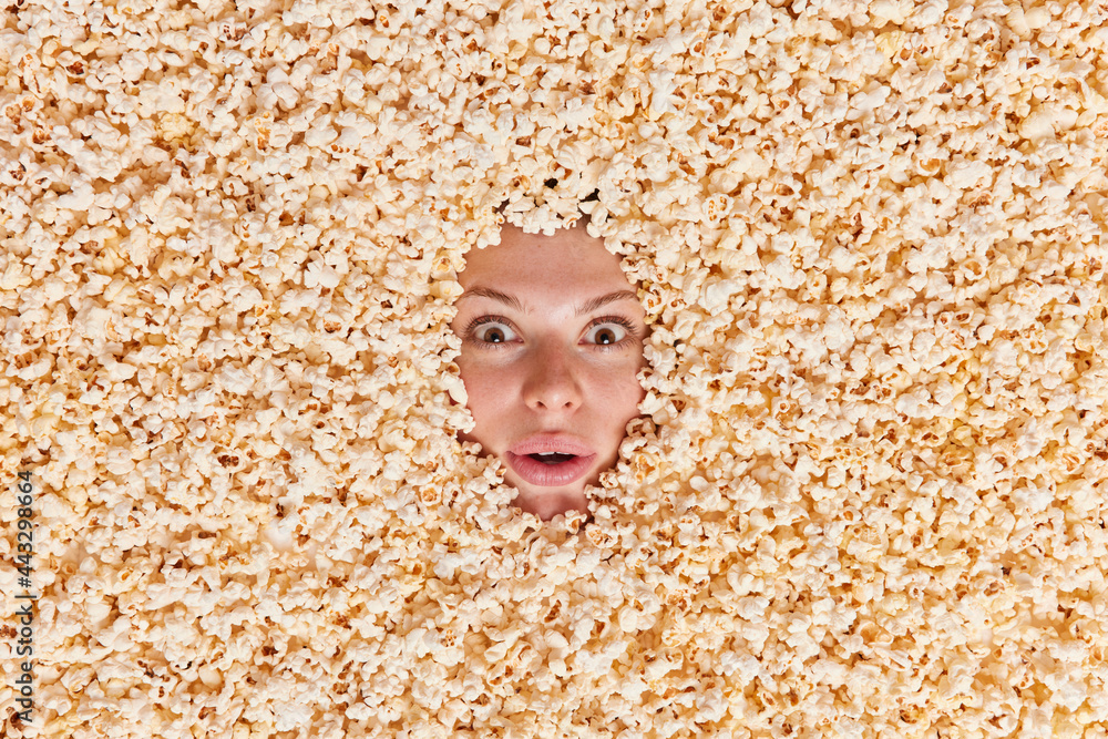 Overhead shot of surprised woman stares bugged eyes feels impressed ...