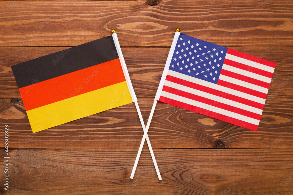 Flag of Germany and flag of USA crossed with each other. The image ...