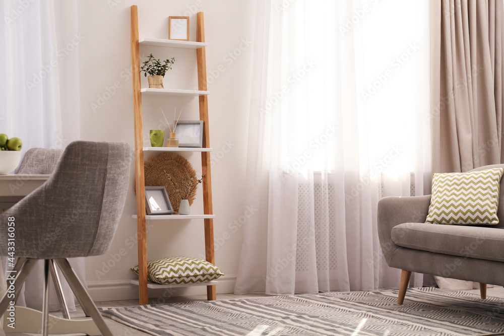 Stylish living room interior with wooden ladder near white wall Stock ...