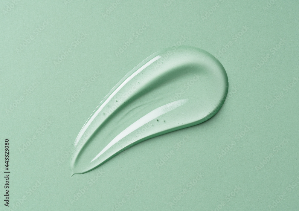 Transparent gel drop on green background. Liquid gel cosmetic stain ...