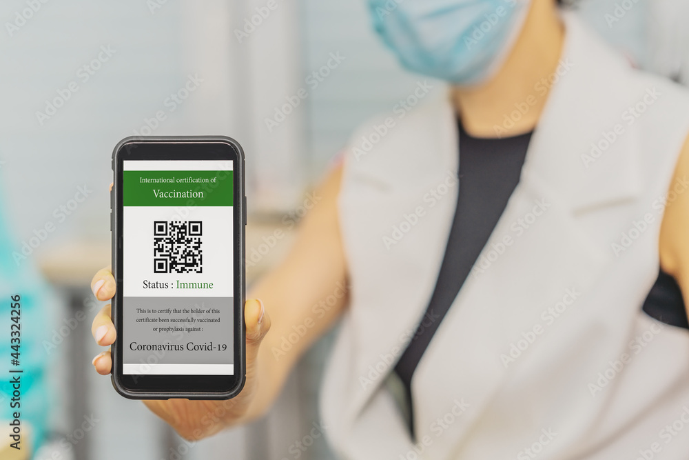 digital covid-19 vaccination certificate with QR code on smartphone ...