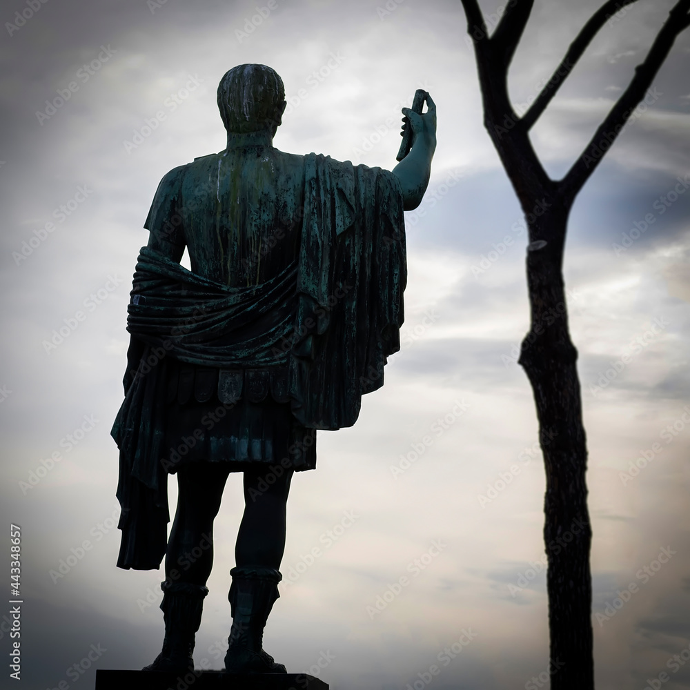 Silhouette of Caesari Nervae statue in dei Fori Imperiali street in ...