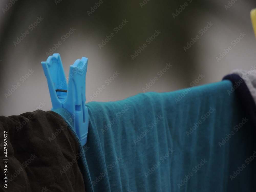 clothes hanging on a clothesline with clothspin Stock Photo | Adobe Stock