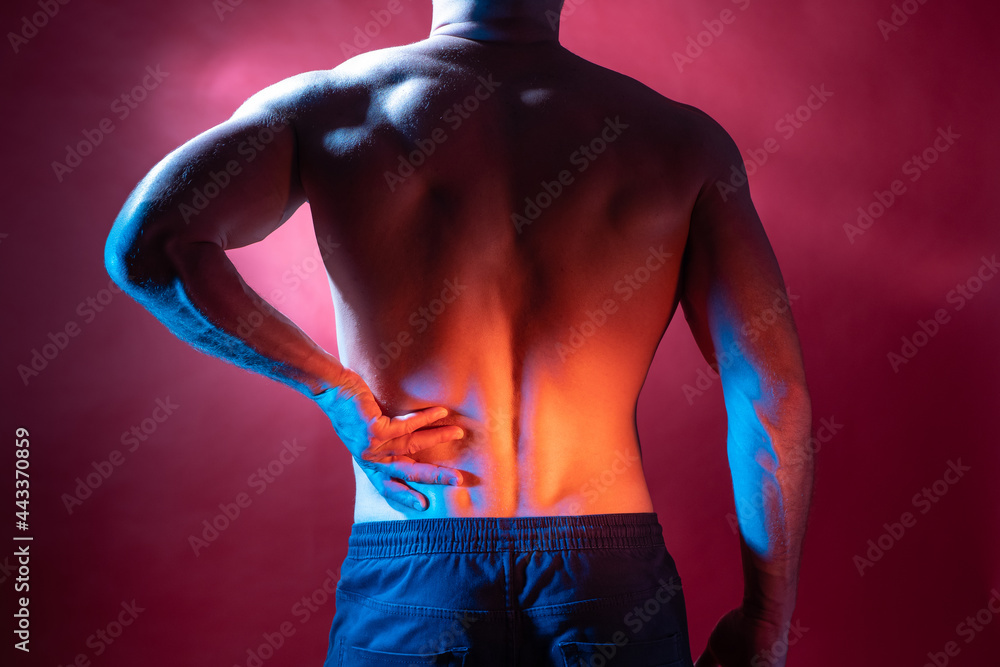 Back pain. Concept - person is tormented by problems with lower back ...